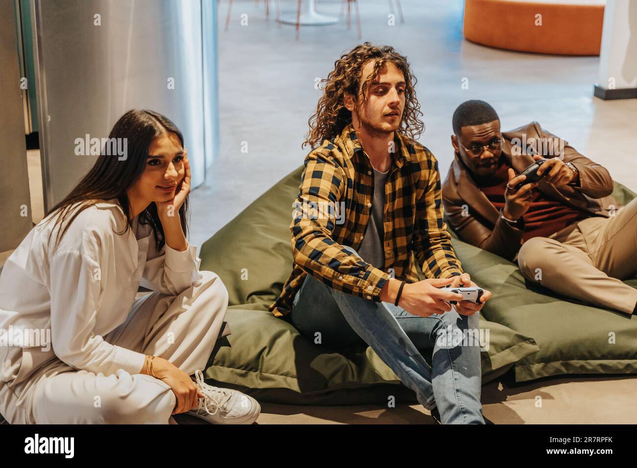 Multiracial colleagues having fun at work while taking a break. They ...