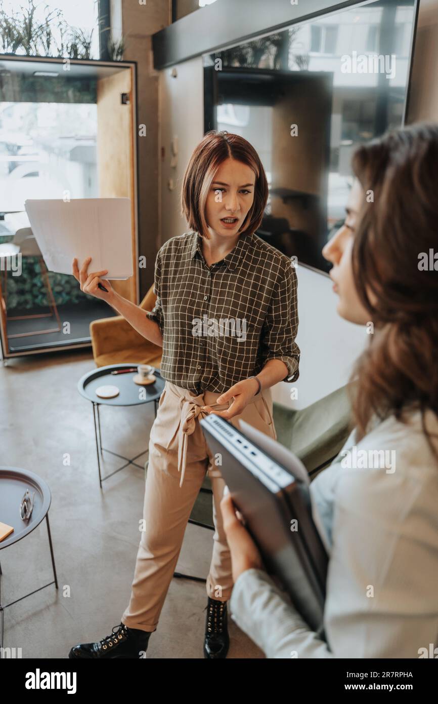 Business girls having a conversation about their clients while taking a ...