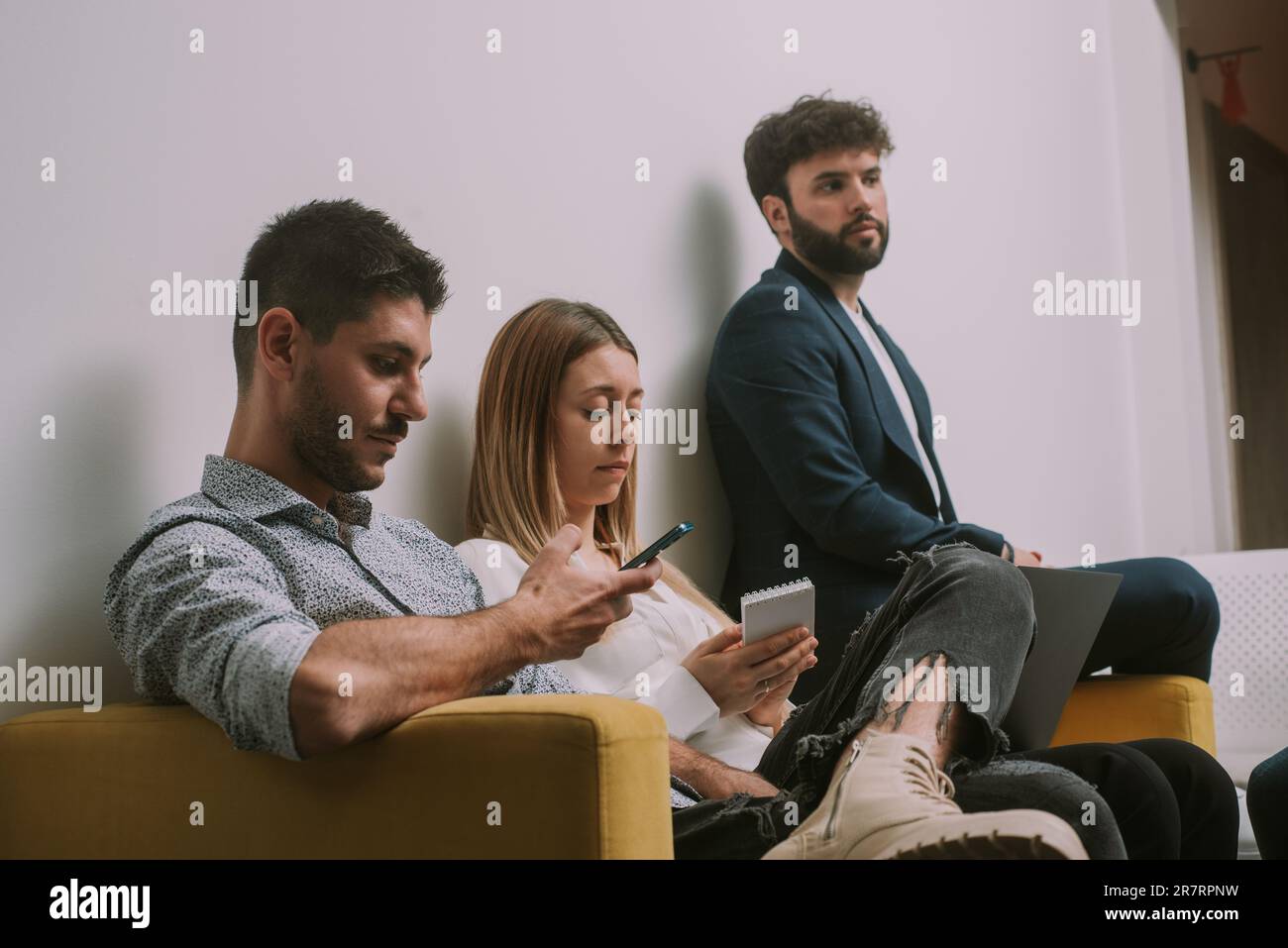 A side view photo of male person scrolling on her phone while his ...