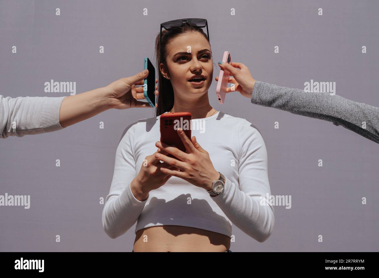 Beautiful brunette girl is answering many phone calls while looking ...