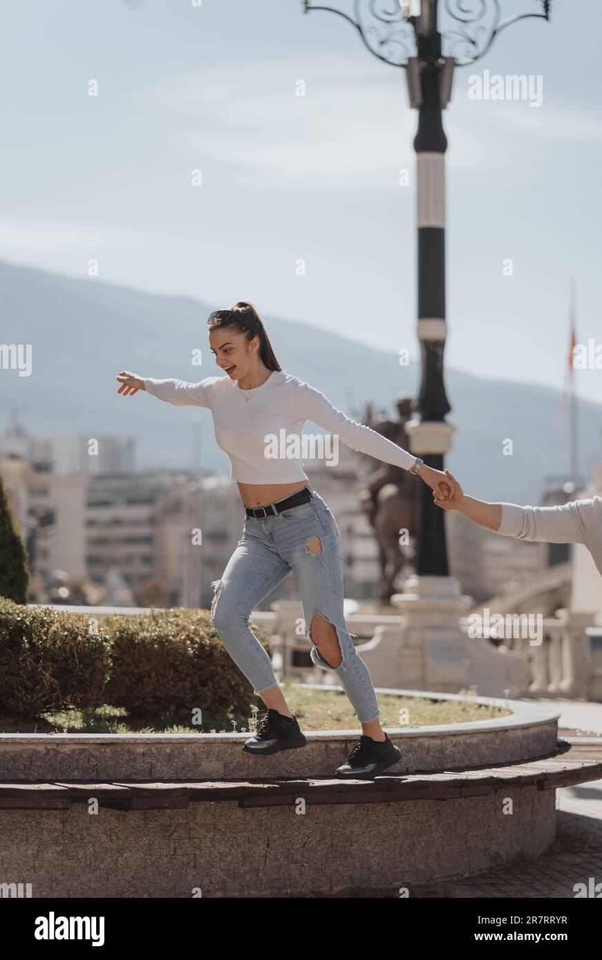 Beautiful girl having fun while running and holding her boyfriend at ...