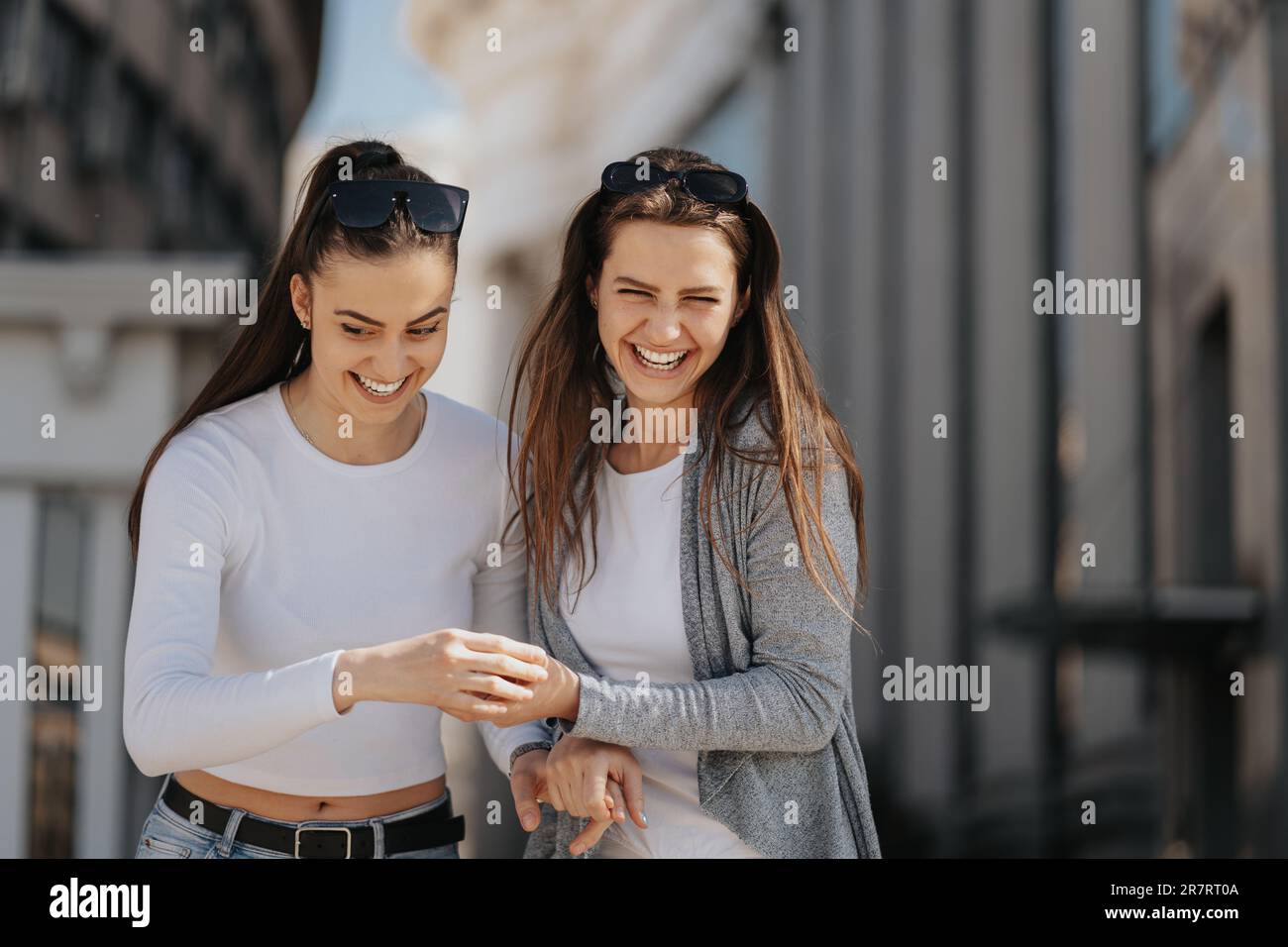 Two young women standing next to each other Stock Photo - Alamy