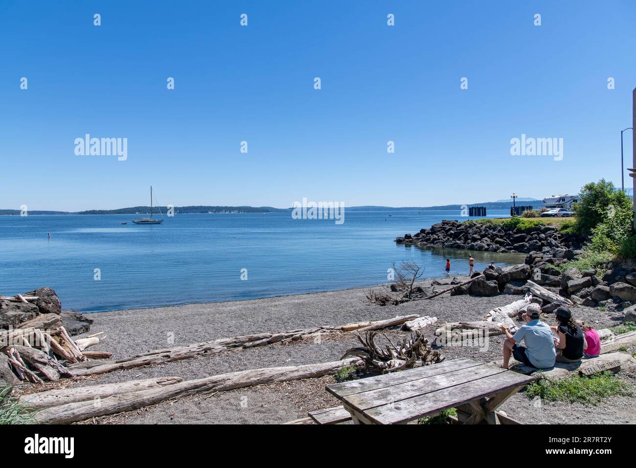 View over a small beach with people enjoying some lunch and others ...