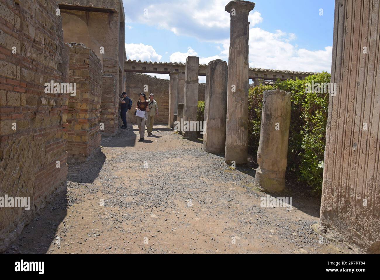 Tourists viewing the preserved Roman town of Herculaneumm buried in the ...