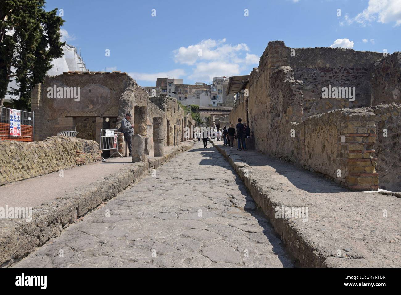 Tourists viewing the preserved Roman town of Herculaneumm buried in the ...