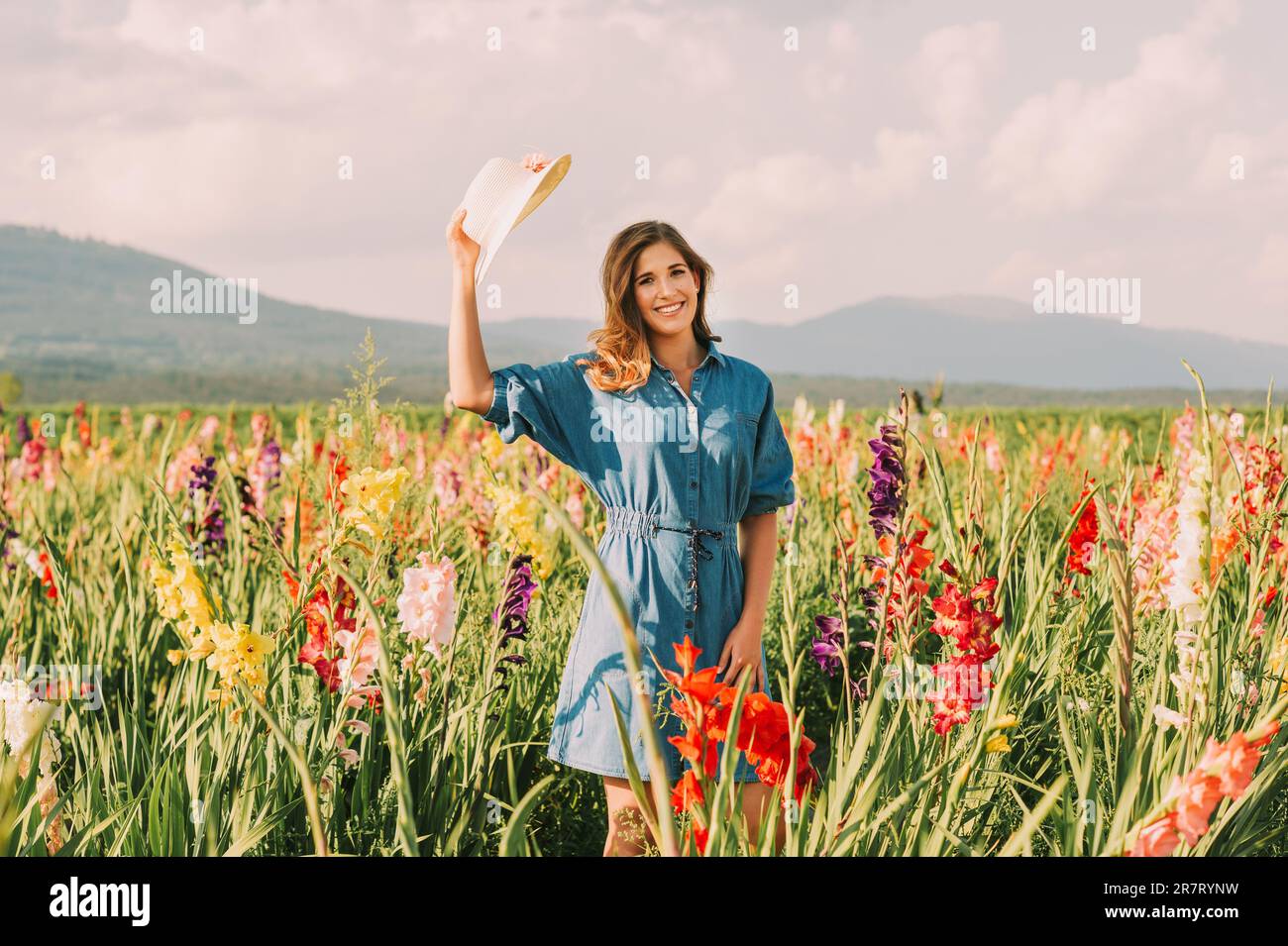 Outdoor portrait of pretty young girl in countryside, wearing denim ...