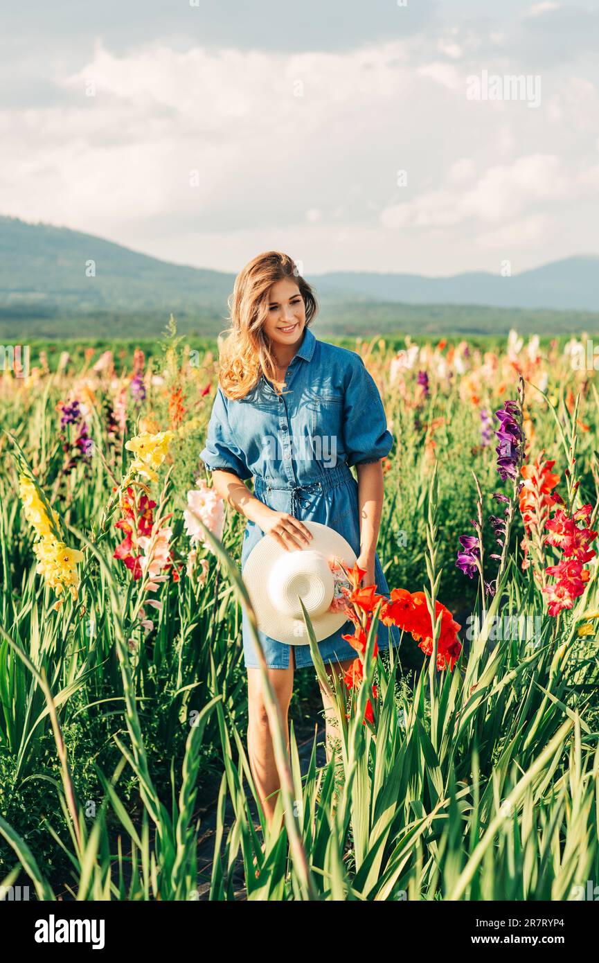 Outdoor portrait of pretty young girl in countryside, wearing denim ...