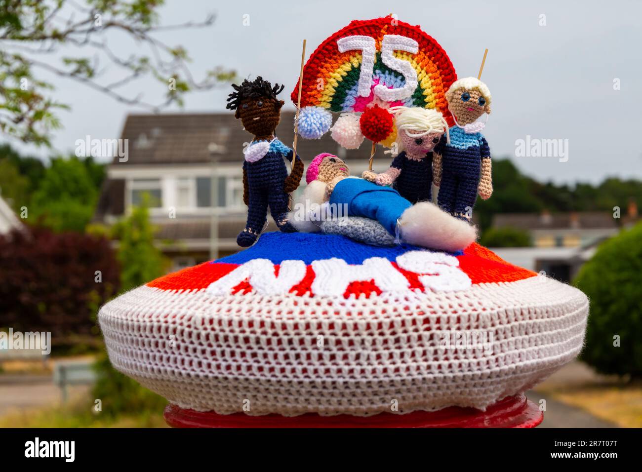 Poole, Dorset, UK. 17th June 2023. A knitted crocheted postbox topper ...