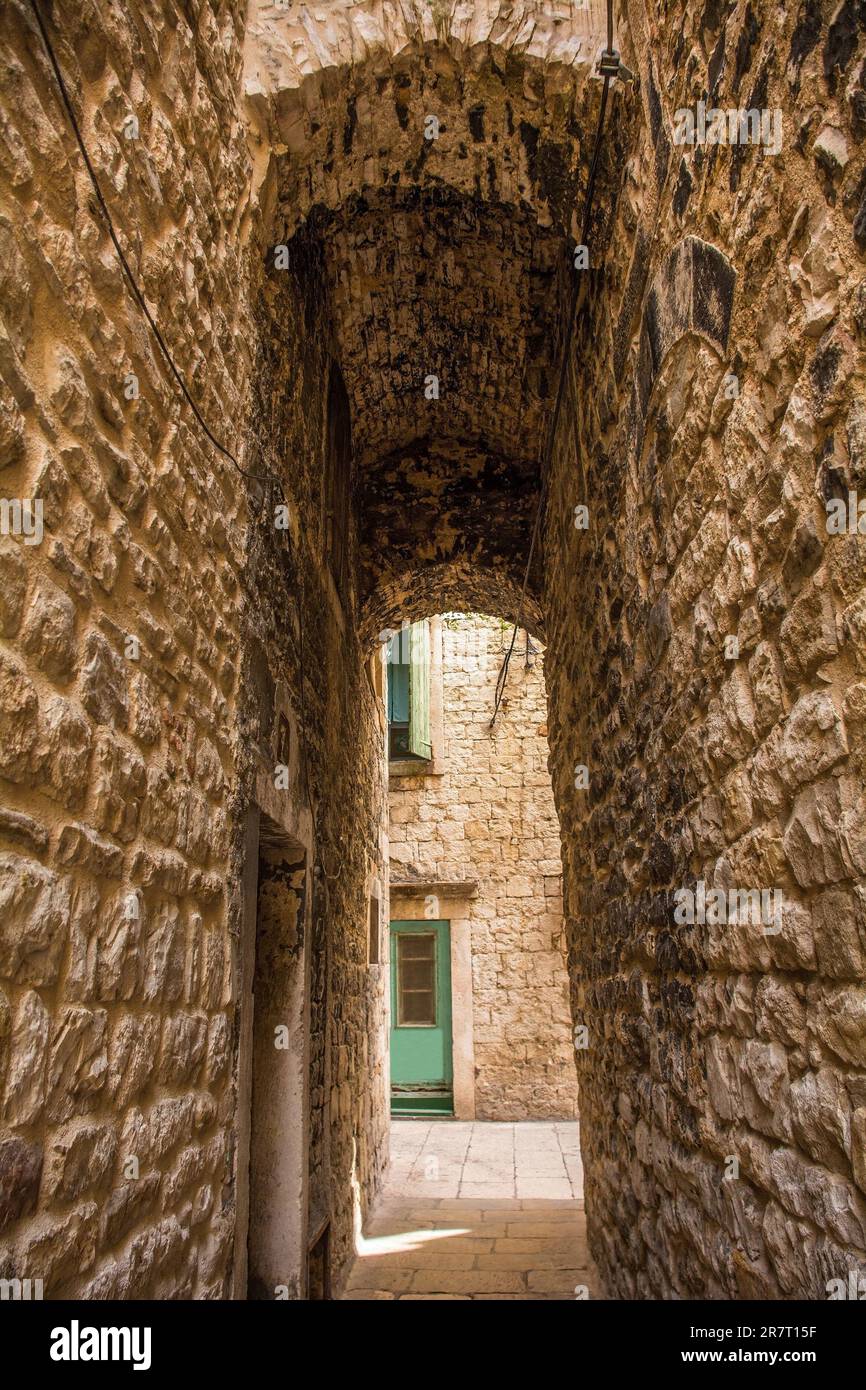 An arched alleyway in a quiet back street in the historic coastal city ...