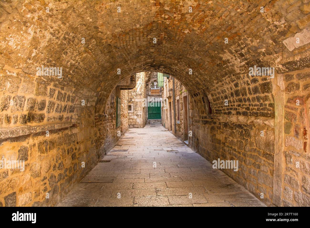 An arched alleyway in a quiet back street in the historic coastal city ...