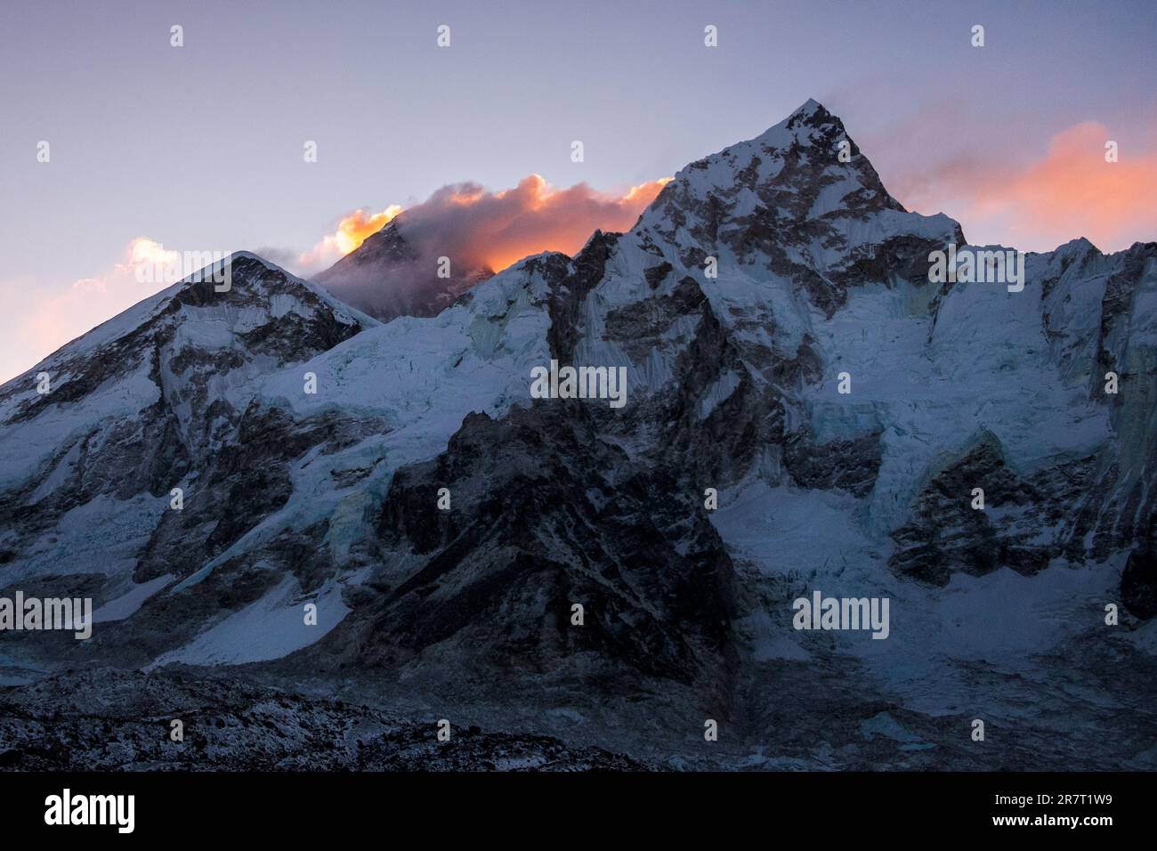 Nuptse in the foreground and Mount Everest at dawn during a trekking ...