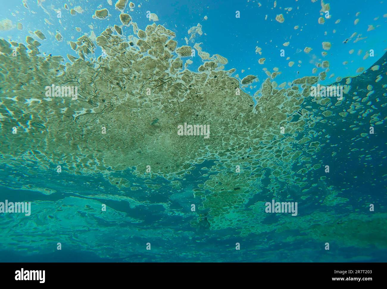 An oily fatty layer of garbage slowly drifts on surface of sea. Waste ...