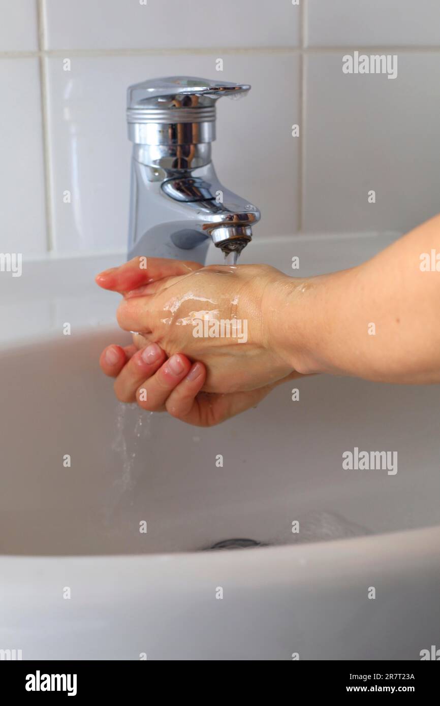 Senior woman washing hands hi-res stock photography and images - Alamy