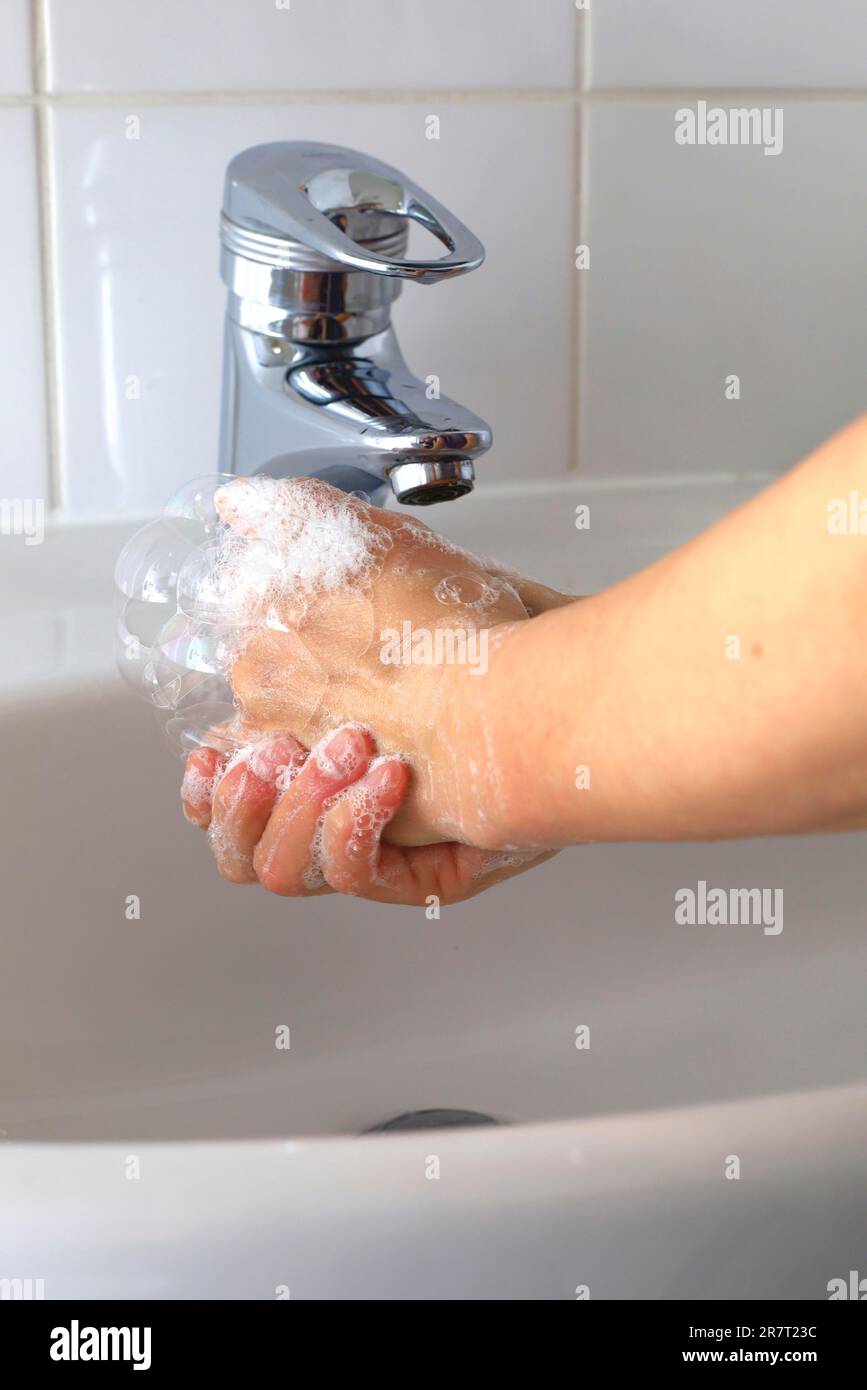 Senior woman washing hands hi-res stock photography and images - Alamy