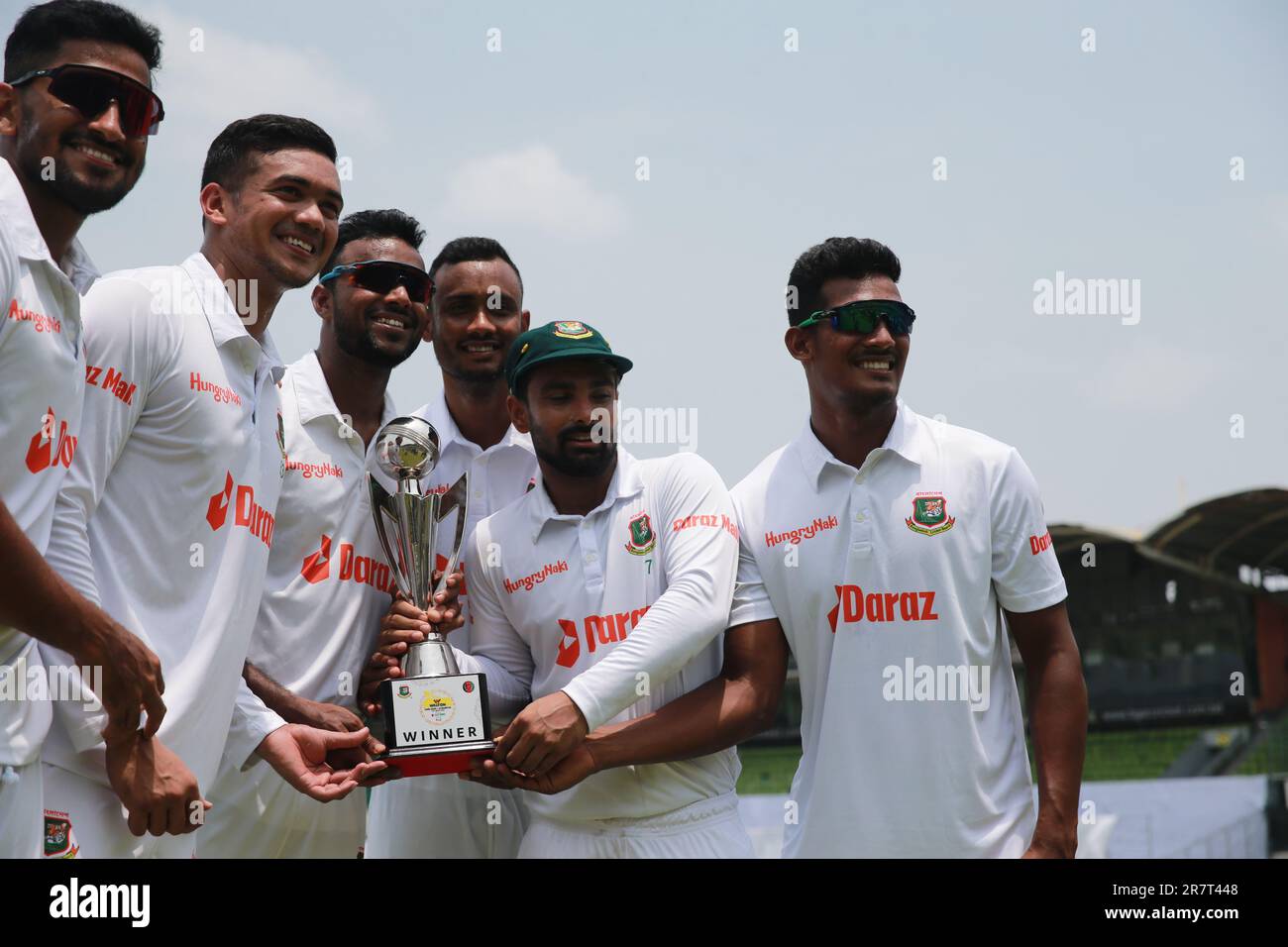 Litton Das (2nd right) holds the lone Test match trophy along the five ...