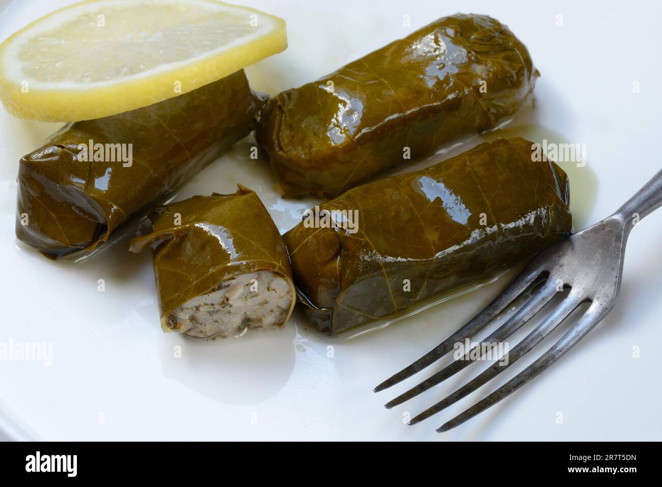 Vine leaves with rice filling on plate Stock Photo - Alamy