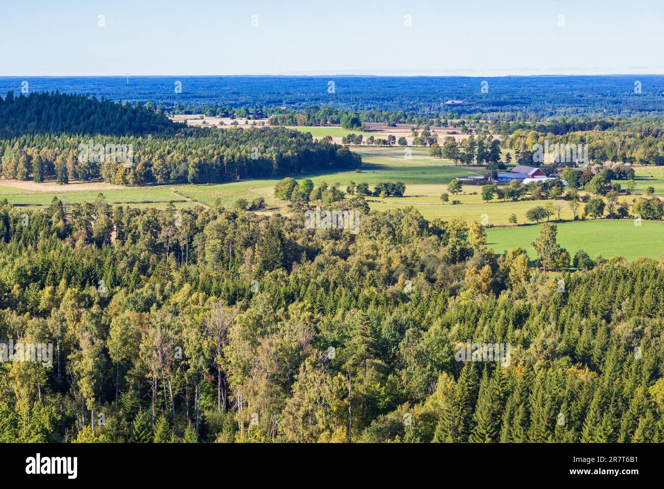 Aerial view of a landscape with fields, farms and forest to the horizon ...
