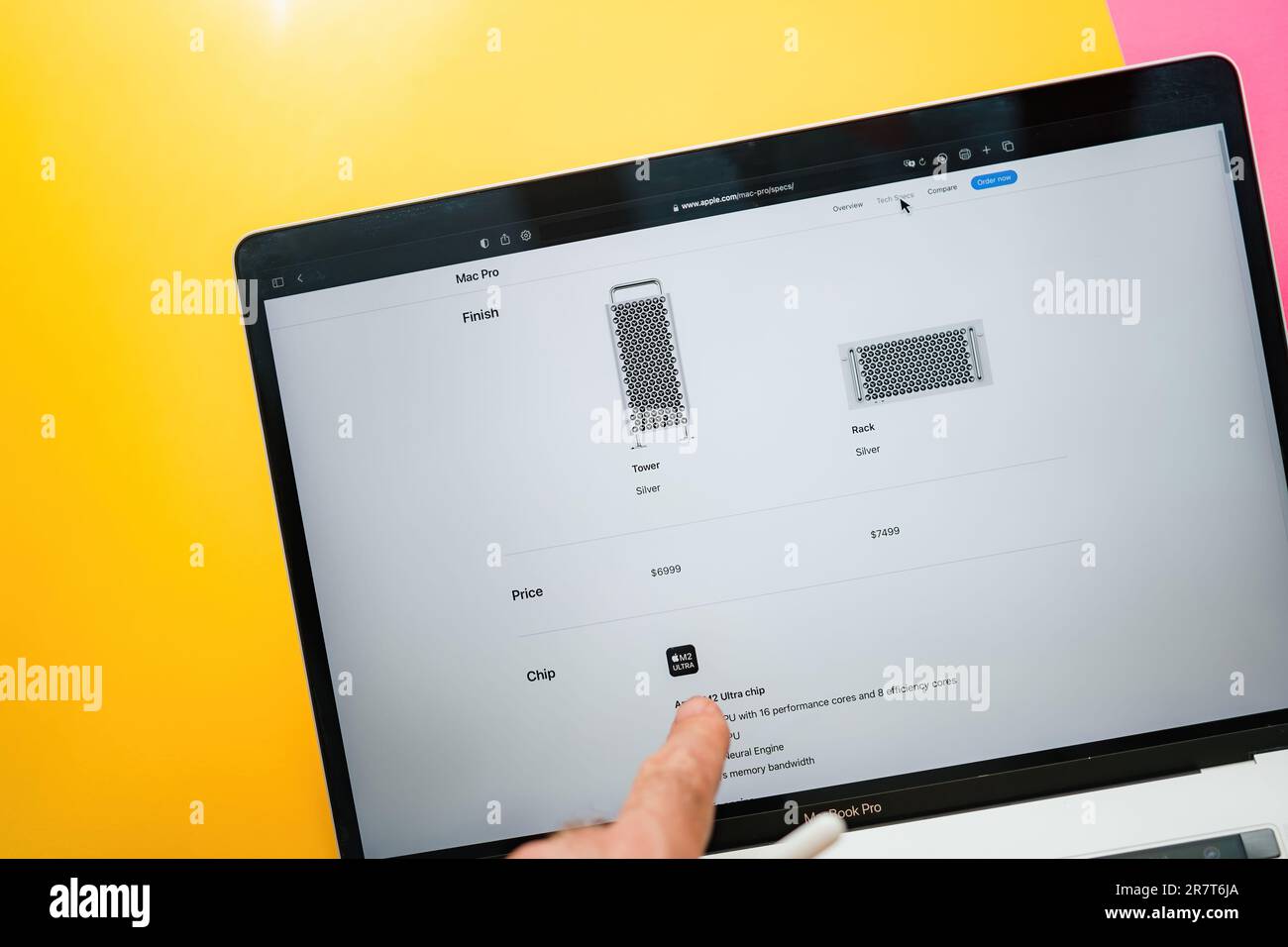 Paris, France - Jun 6, 2023: Hand pointing to Mac Pro workstation with ...