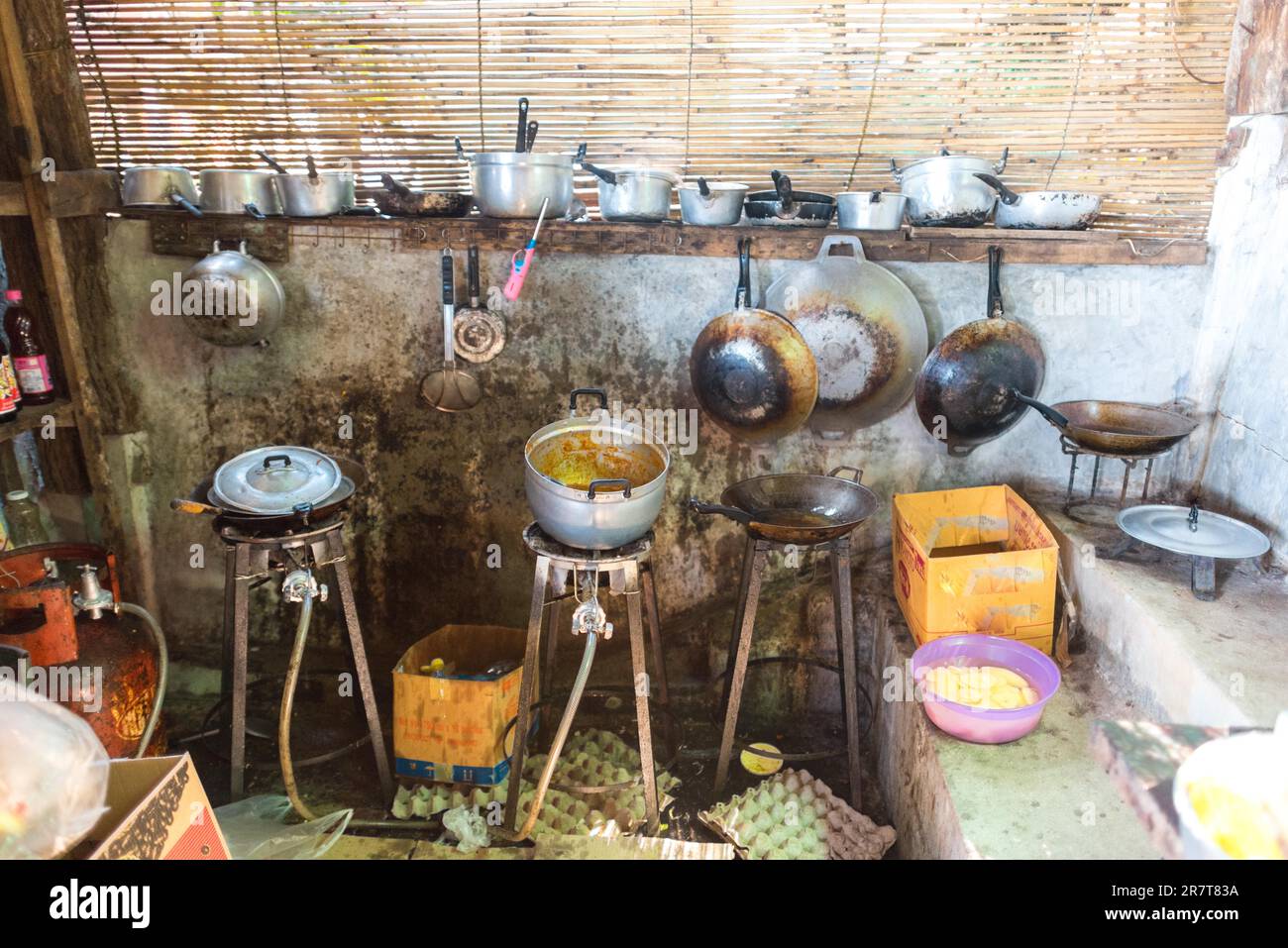 Typical kitchen in Thai style with gas stove, wok and a lot of pots and ...