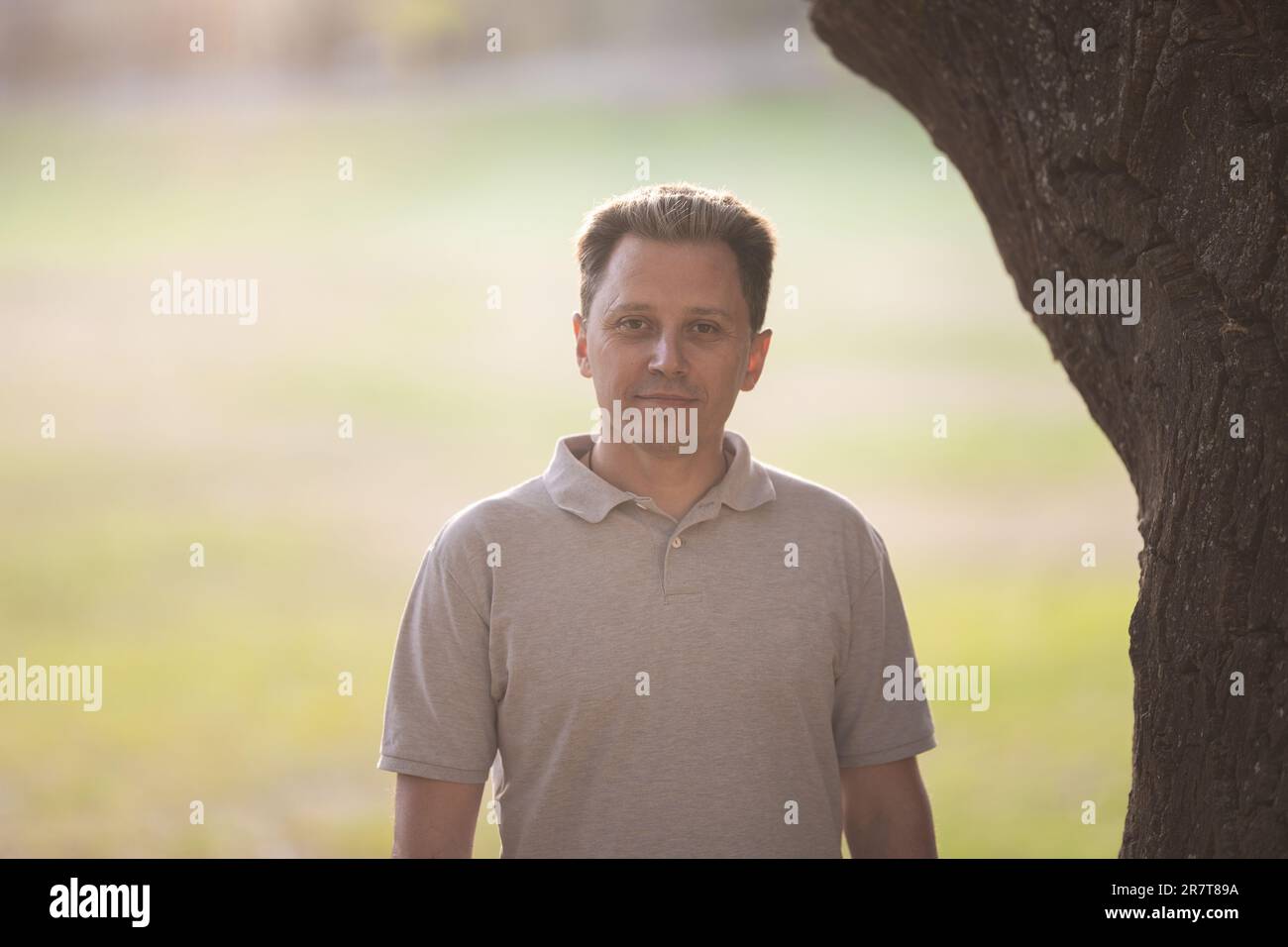 Smiling white man standing on nature. Portrait Stock Photo - Alamy