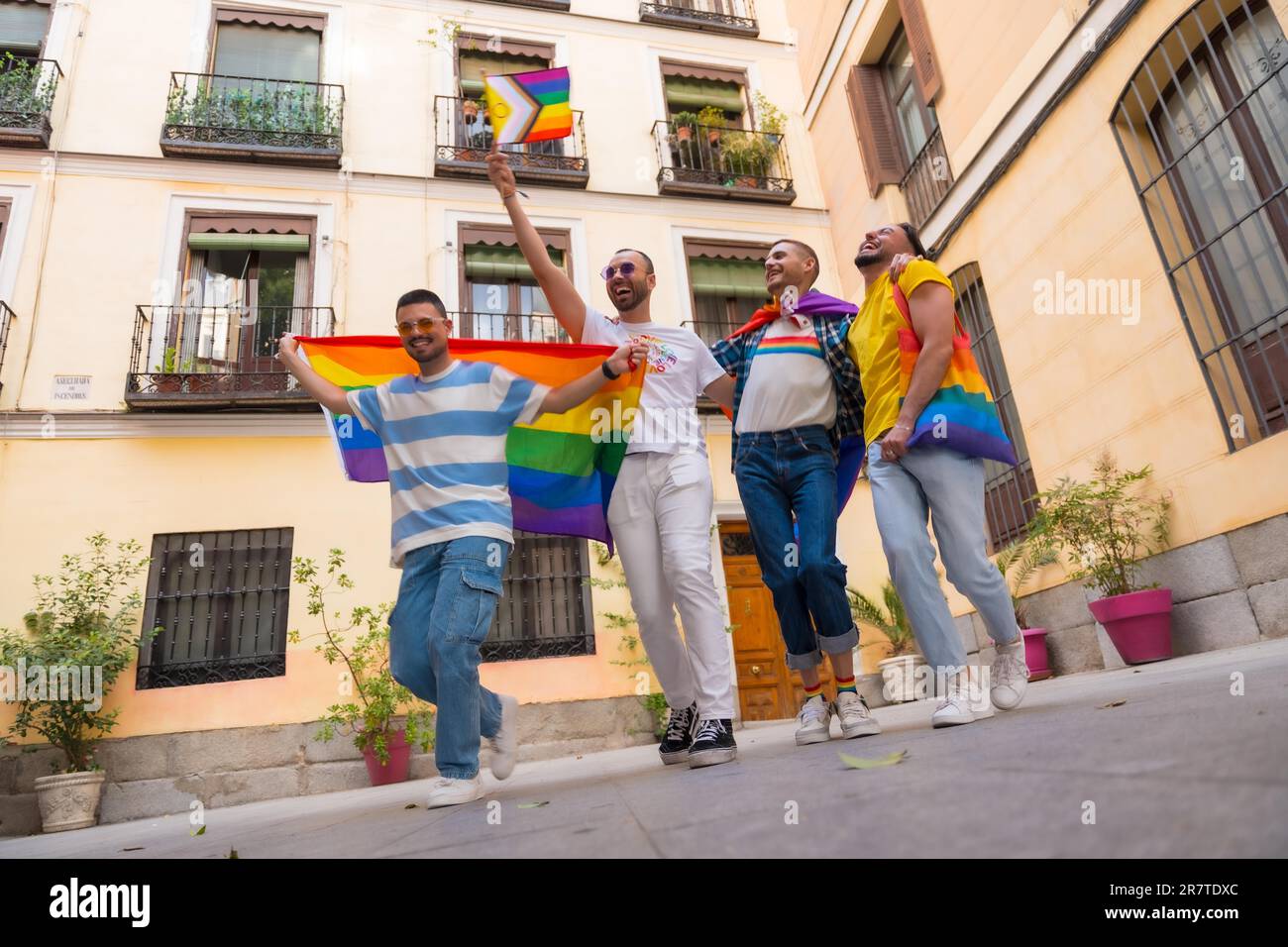 Homosexual male friends jumping for joy at gay pride party, diversity ...
