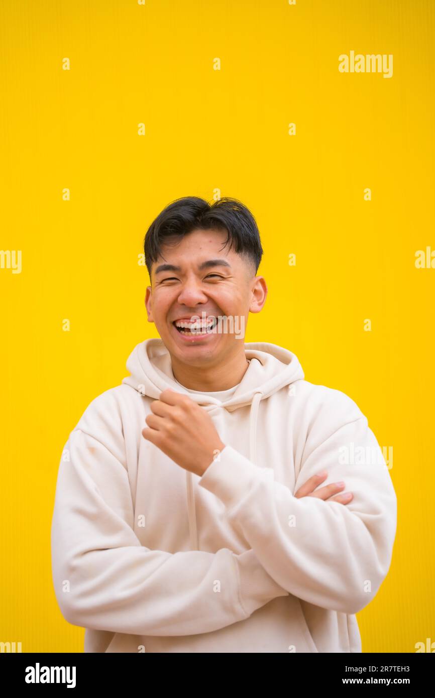 Portrait of a handsome South Korean Asian man in basic clothes smiling ...
