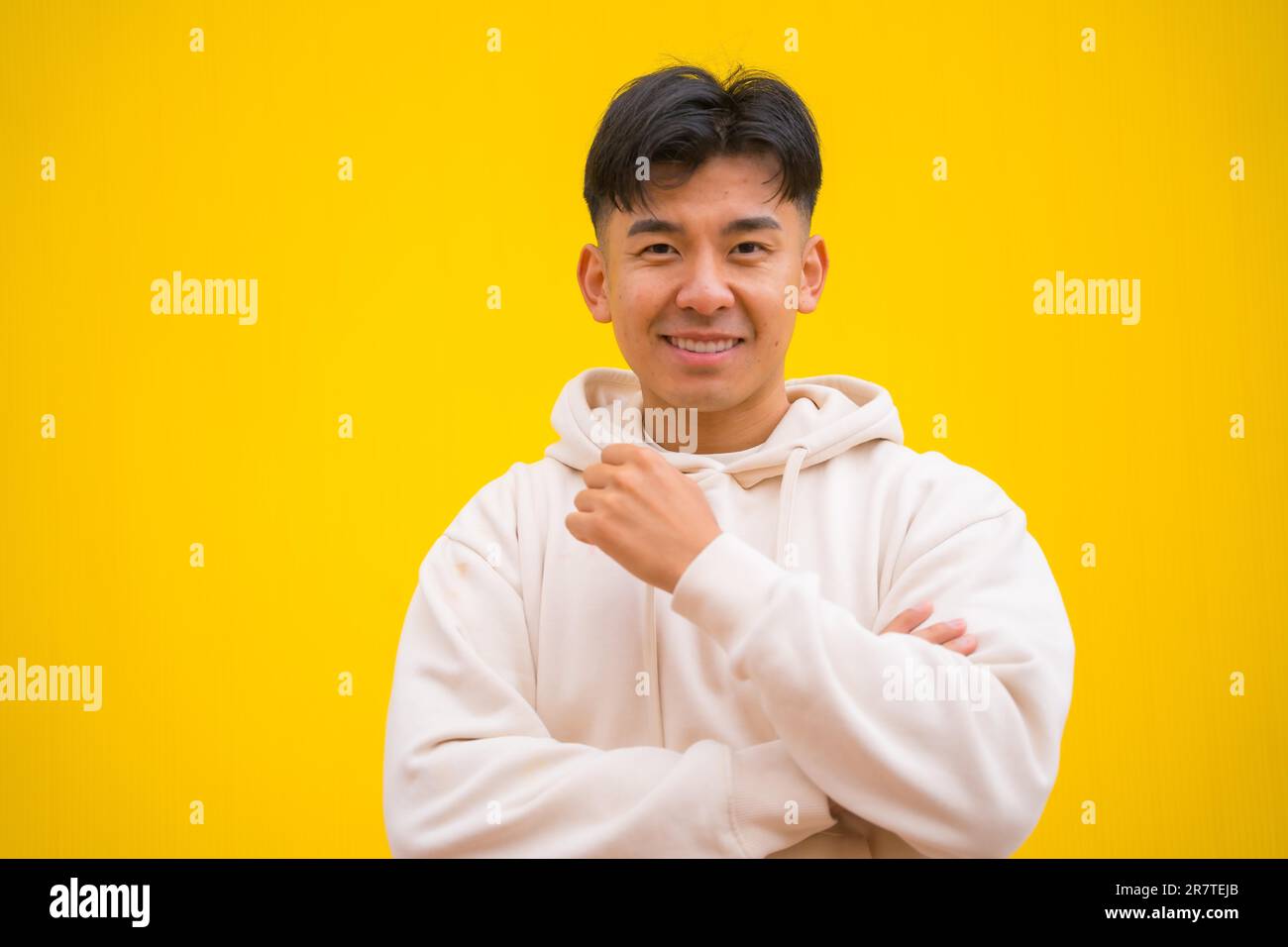 Portrait of a handsome South Korean Asian man in basic clothes smiling ...