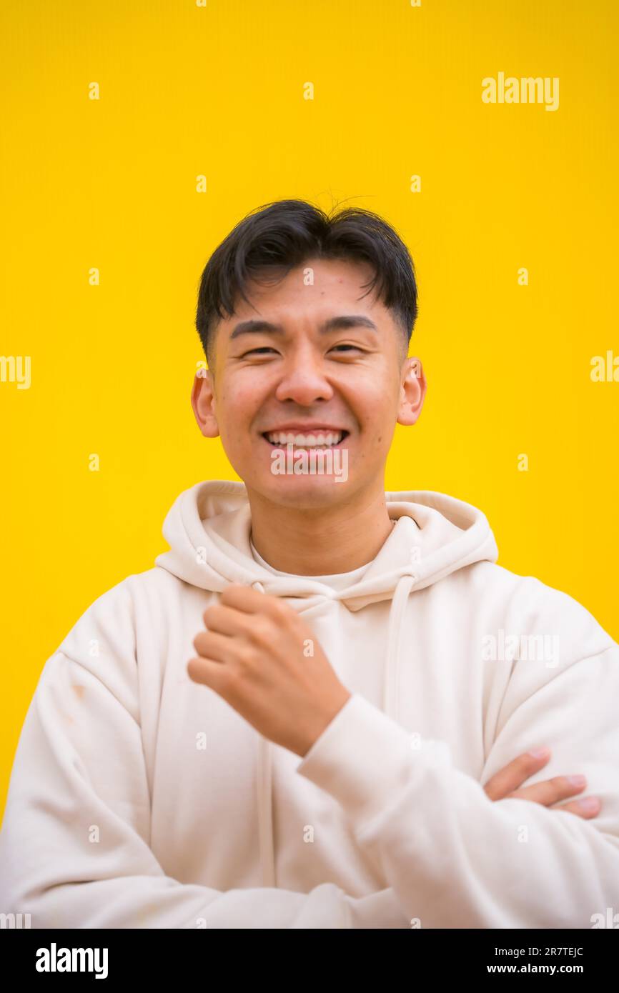 Portrait of a handsome South Korean Asian man in basic clothes smiling ...