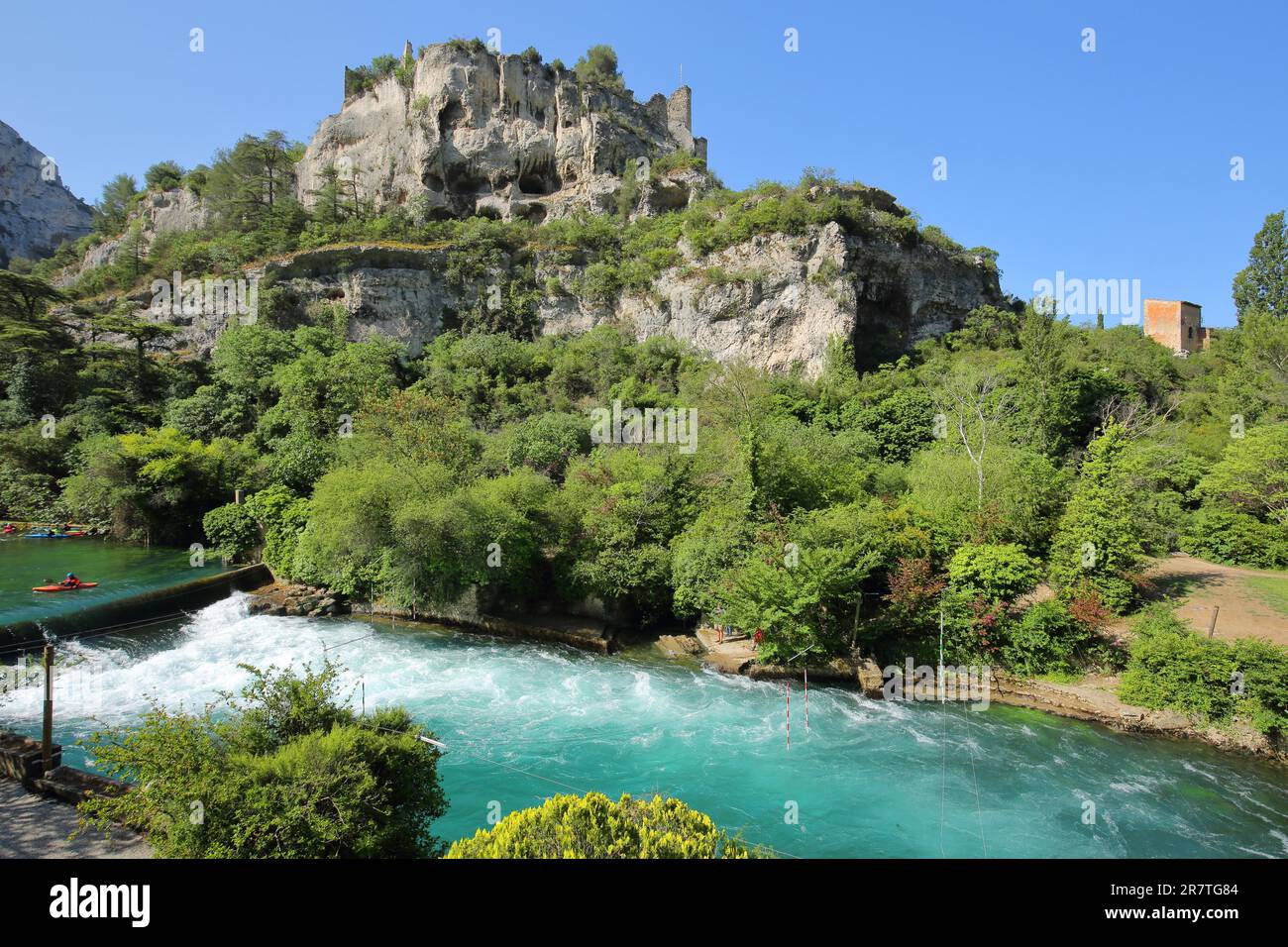 View over the river Sorgue with barrage to the Chateau de Petrarque ...