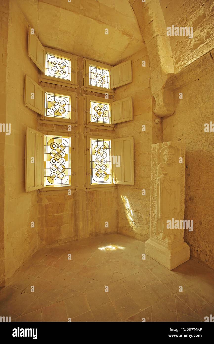 Interior with stained glass window and figure, Romanesque Cloitre St ...