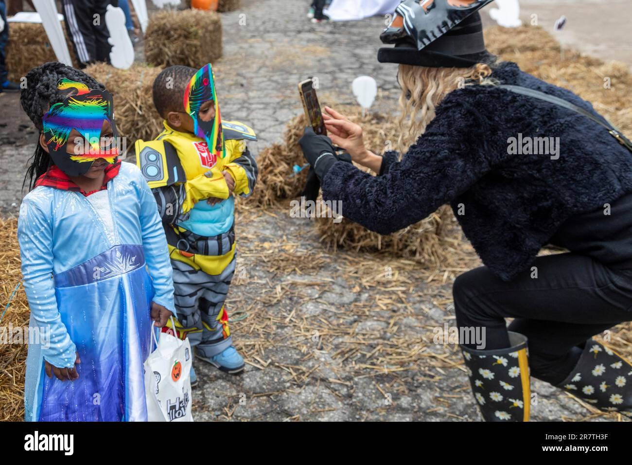 Detroit, Michigan, A woman photographs children in their costumes at ...