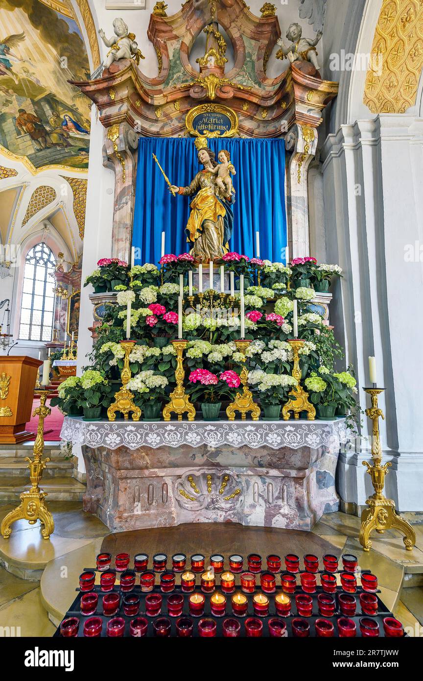 Side altar with figure of the Virgin Mary, floral decorations and ...