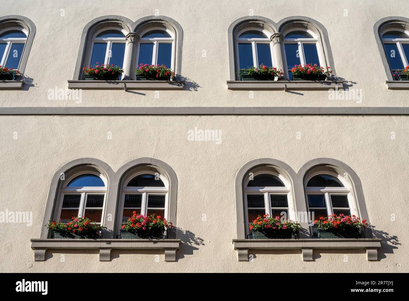 Arched window with decorative flower boxes on a town house in the old ...