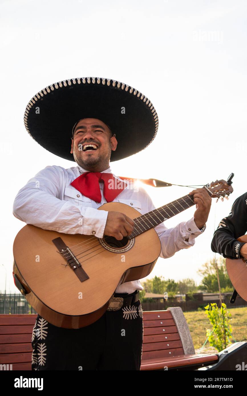 Mexican musician mariachi plays the guitar on a city street Stock Photo ...