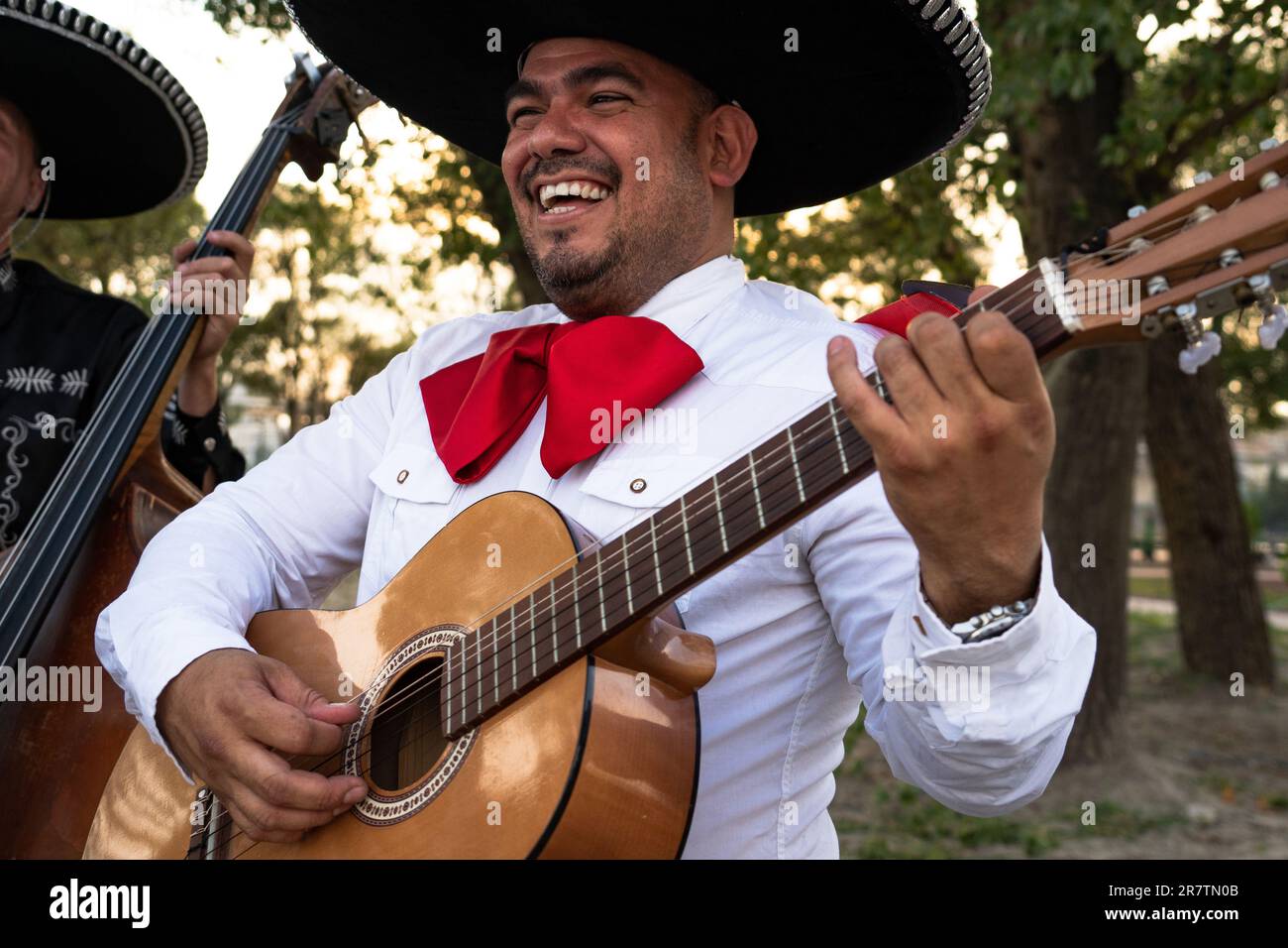 Mexican musician mariachi plays the guitar on a city street Stock Photo ...
