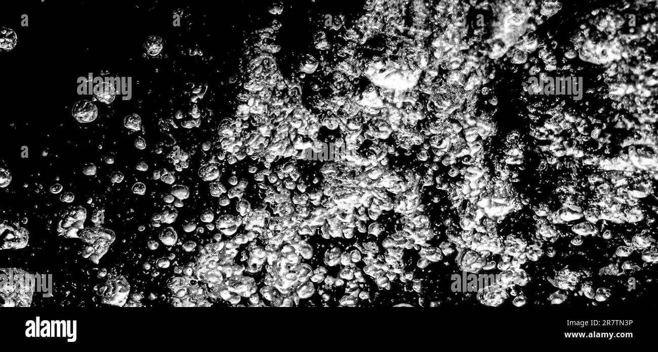 Soda water bubbles splashing underwater against black background. Cola ...
