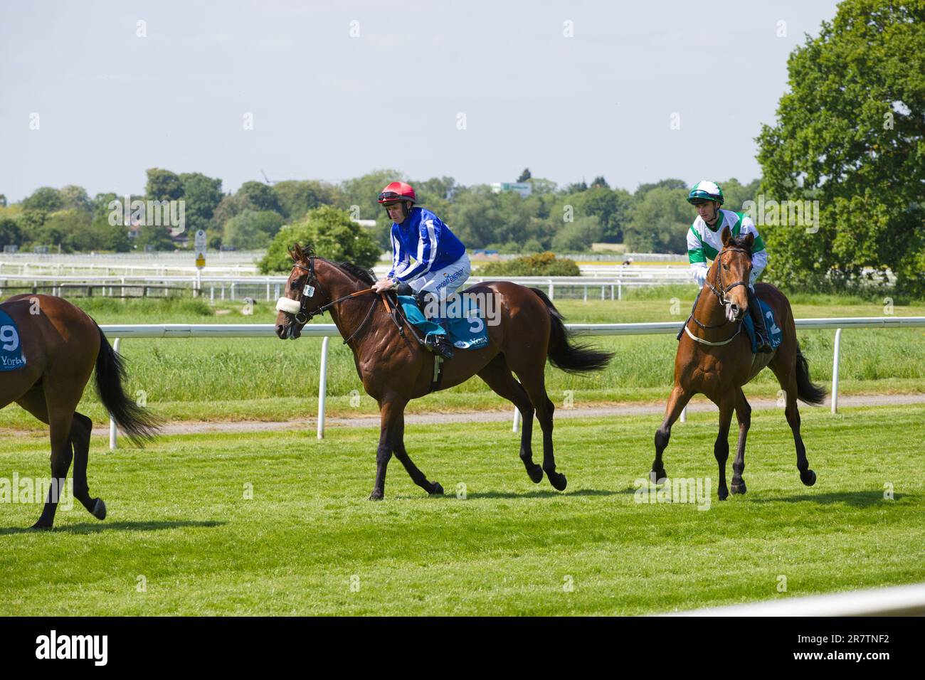 left to right: Jockeys Tom Eaves and Jack Garritty galloping towards ...