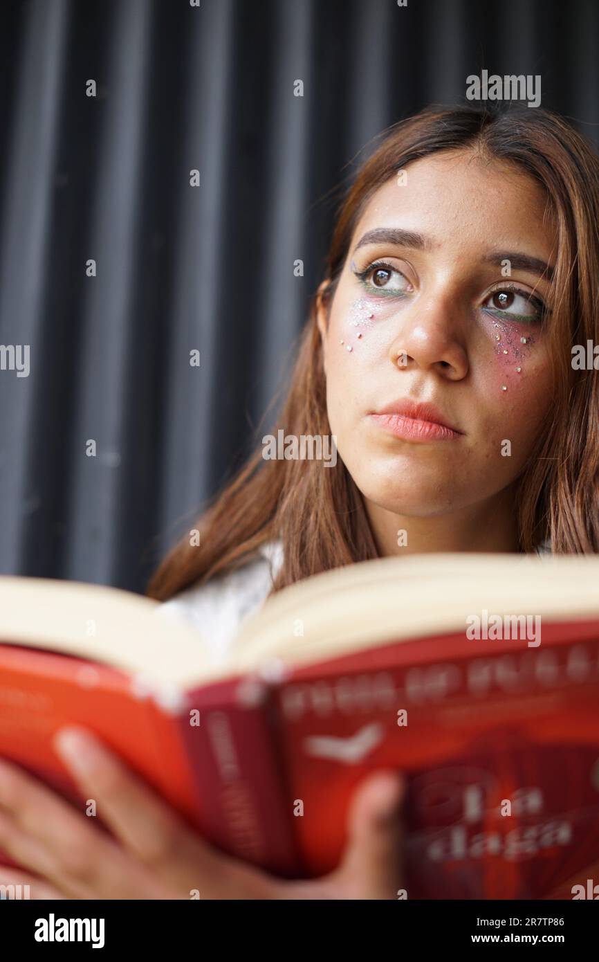 Teenage latin hispanic girl reading a book Stock Photo - Alamy