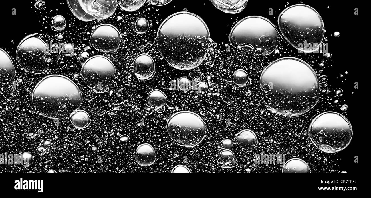 Soda water bubbles splashing underwater against black background. Cola ...