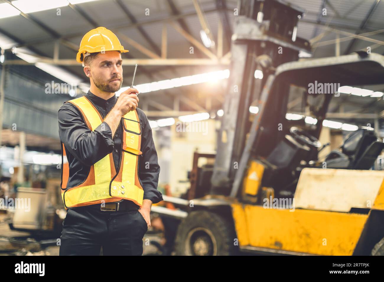 Engineer foreman using walkie talkie radio operate control loading ...