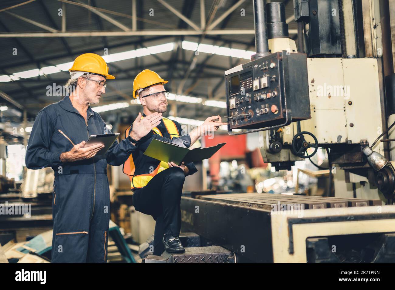 senior male worker training new young engineer employee working in ...