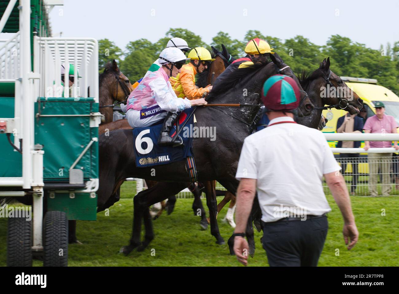 Jockeys and their horses leave the starting gates at York Racecourse ...