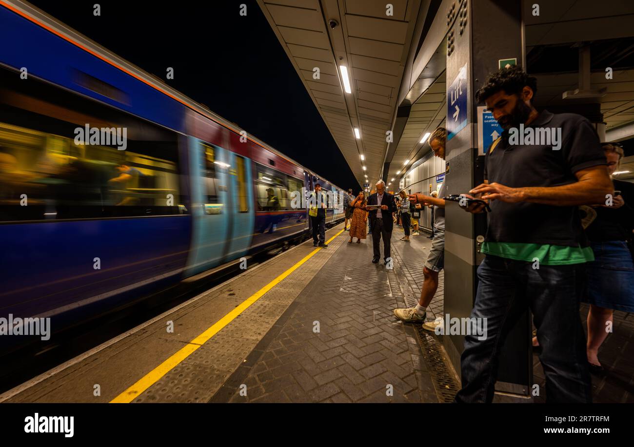London, UK: Passengers wait on a platform at London Bridge railway ...