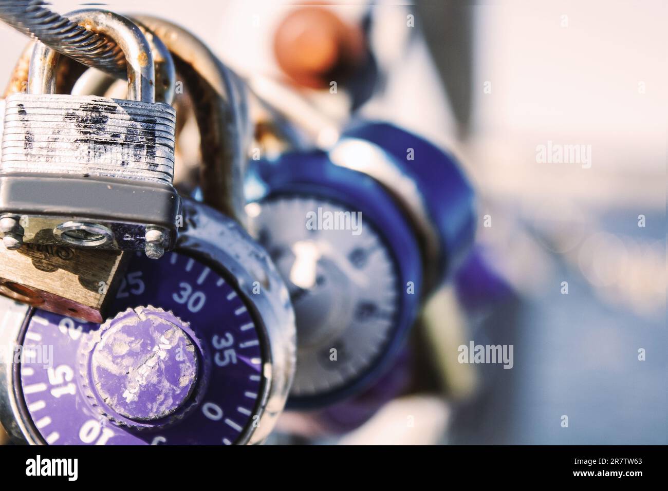 A set of several locks attached to a metal railing by a chain Stock ...