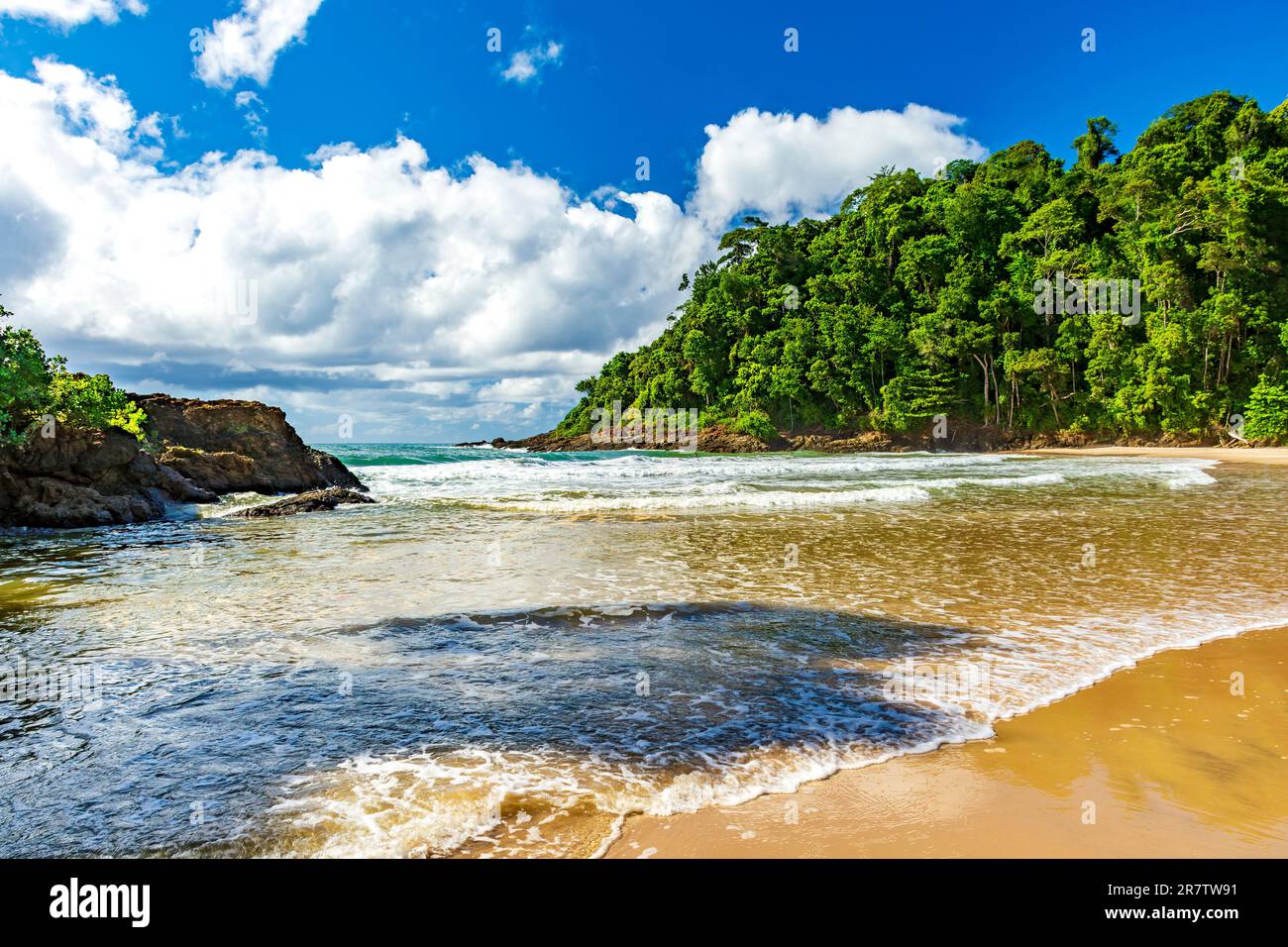 River flowing into the sea at the idyllic Ribeira beach surrounded by ...