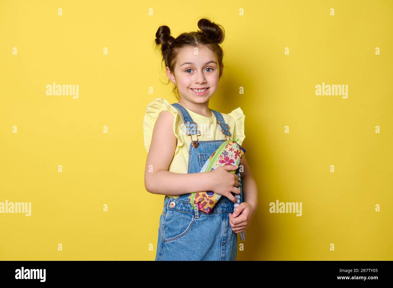 Happy smart primary school student, adorable little child girl holding ...
