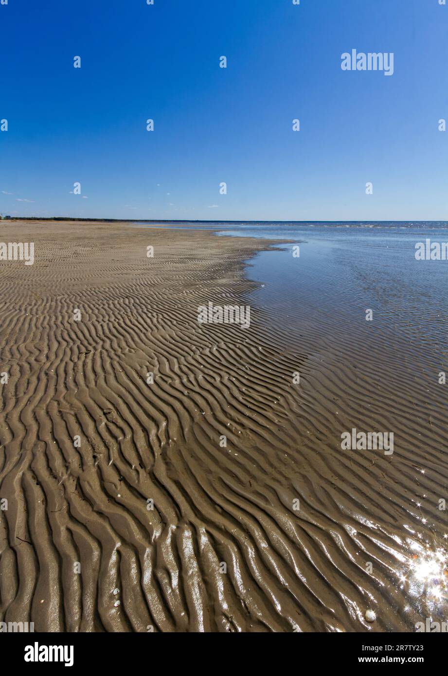 Sandy and wavy seashore Stock Photo - Alamy