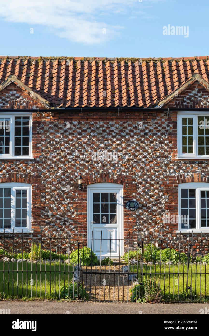 Traditional pretty brick and flint cottage with tiled roof and metal ...