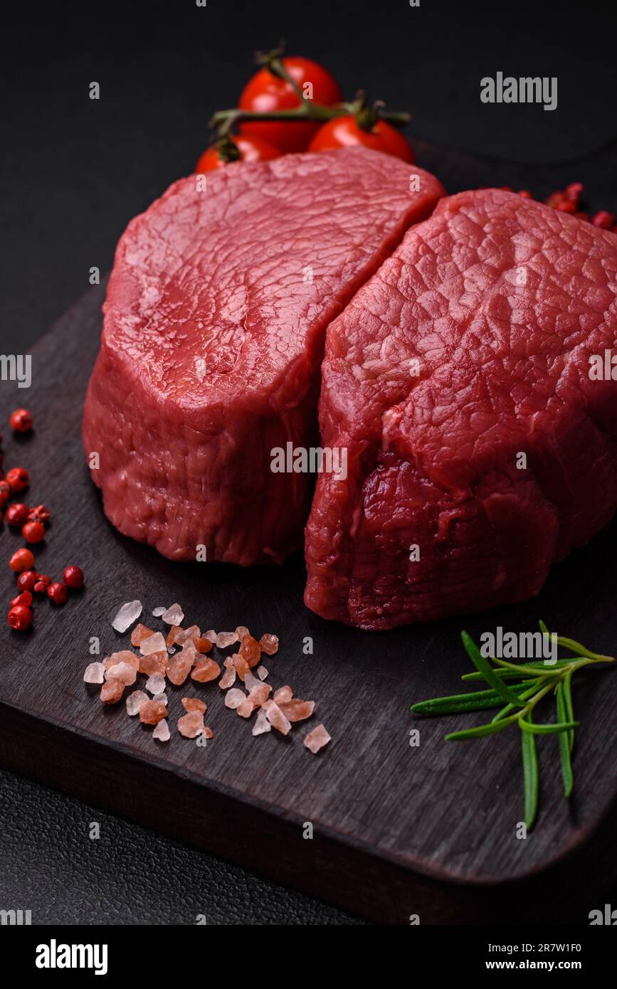 Raw beef eye steak round with salt, spices and herbs prepared for ...