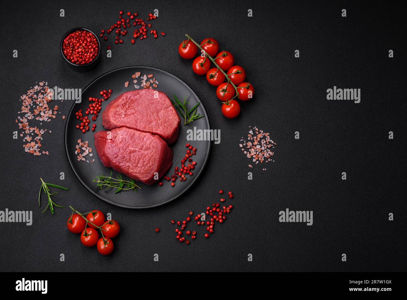 Raw beef eye steak round with salt, spices and herbs prepared for ...